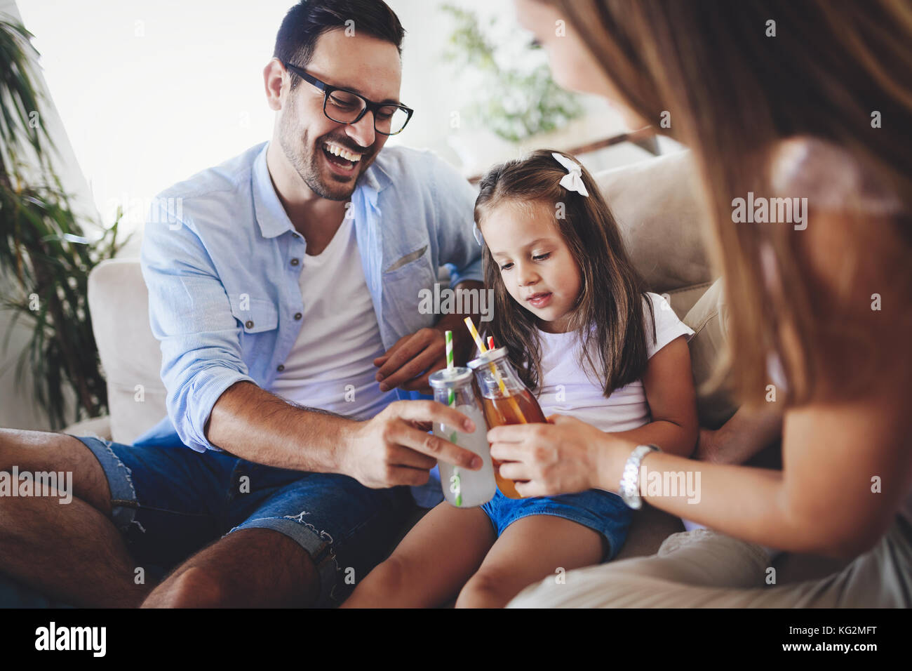Happy family drinking juice together in their house Stock Photo - Alamy