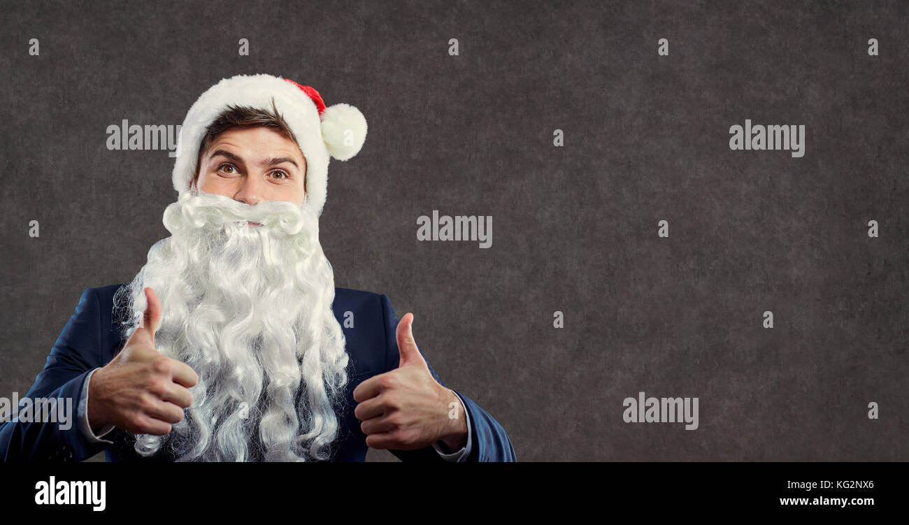 The businessman in Santa Claus costume extended his fingers up Stock ...