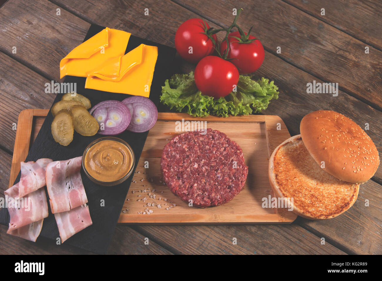 homemade cheeseburger fresh ingredients cheese, bun, salted cucumber ...