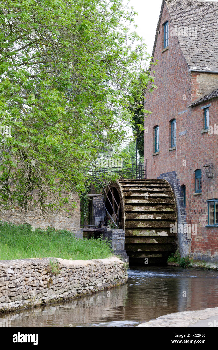 Old water mill in an English countryside with big wooden water wheel ...