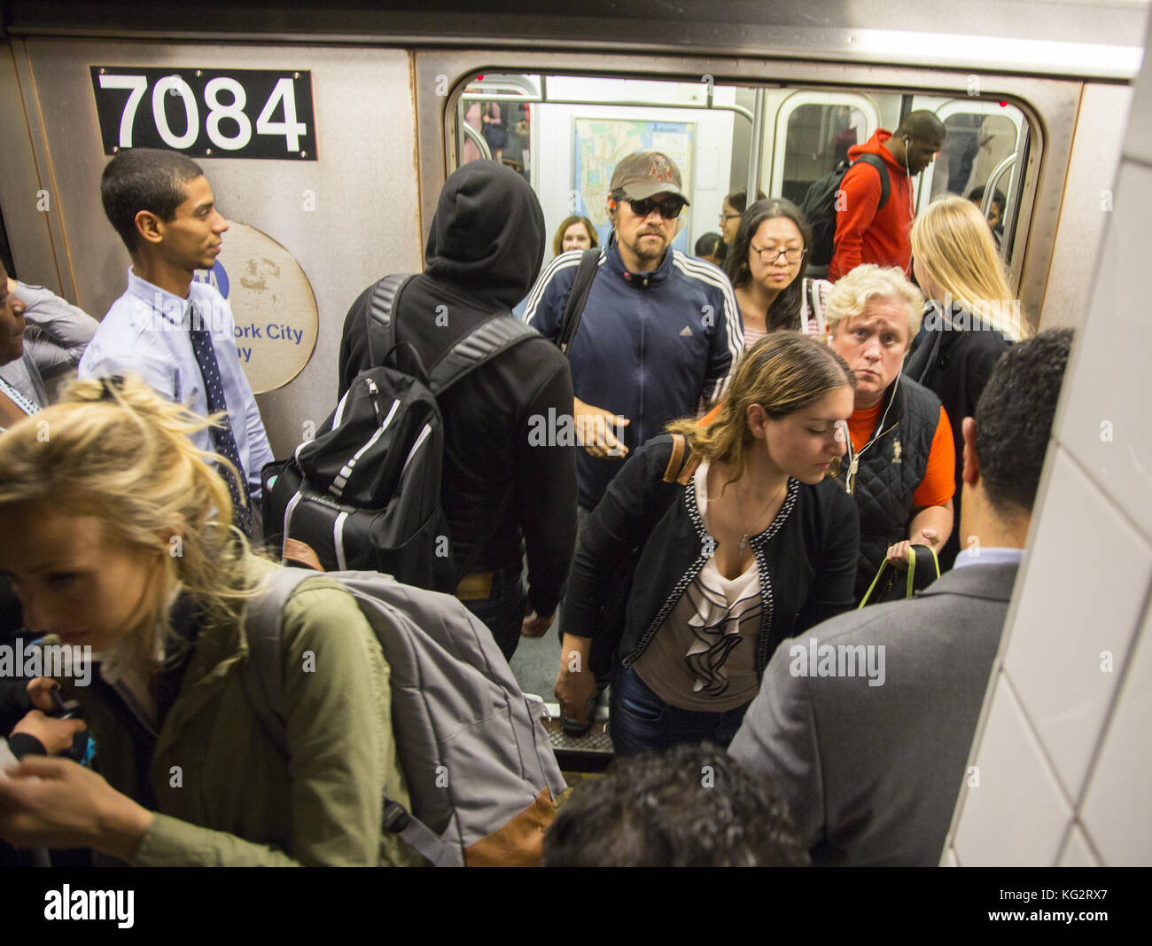 People exit a No. 6 subway train at 59th Street along Lexington Avenue ...