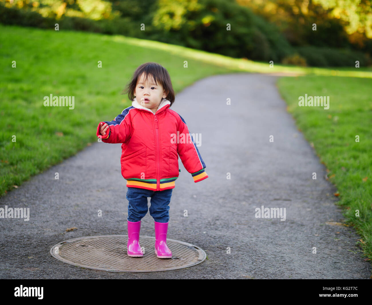 Baby girl playing at Autumn outdoor park Stock Photo - Alamy