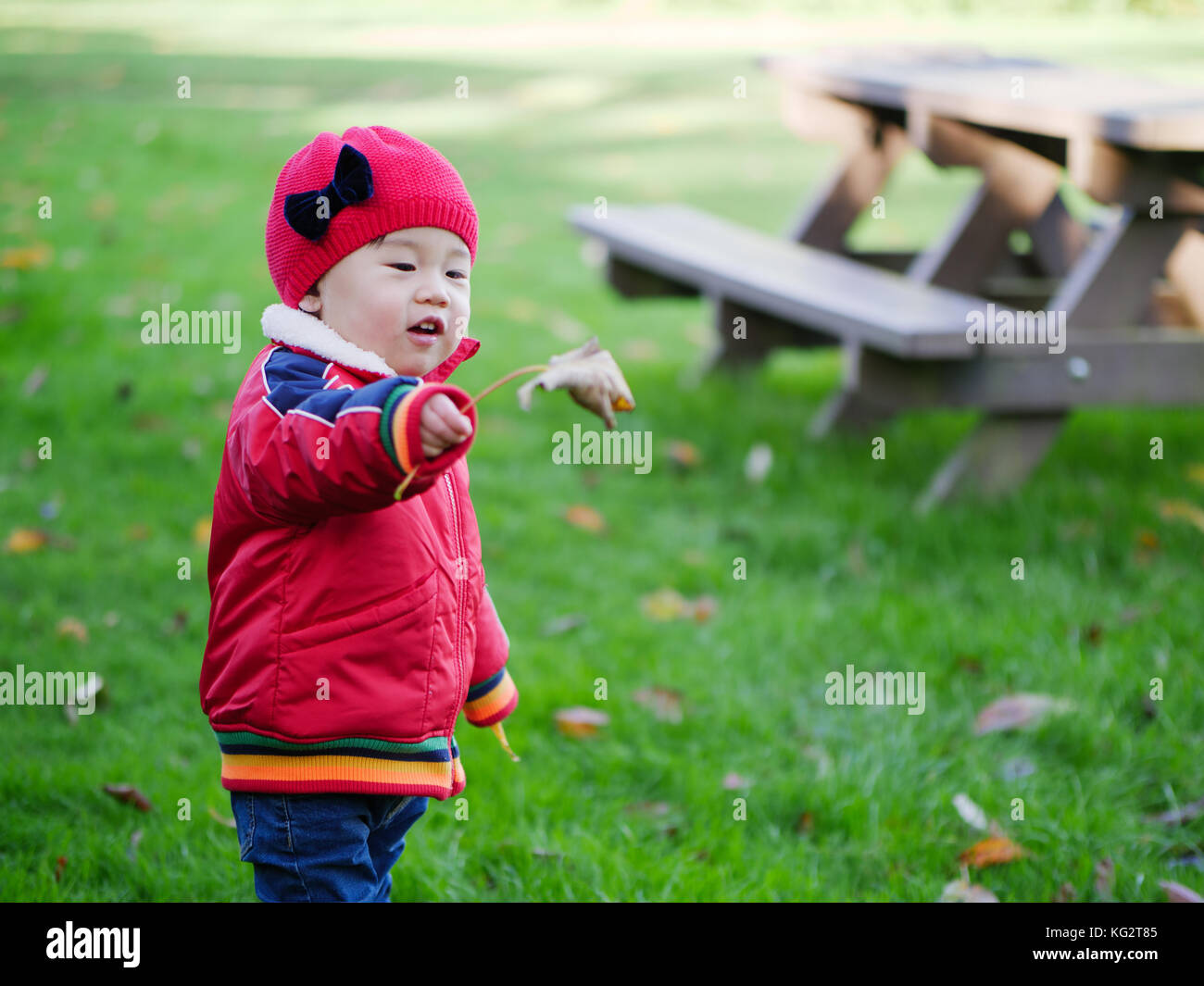 Baby girl playing at Autumn outdoor park Stock Photo - Alamy