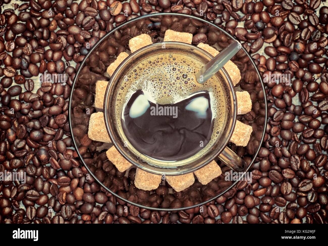 Cup of coffee with lump sugar in the background with coffee beans Stock ...