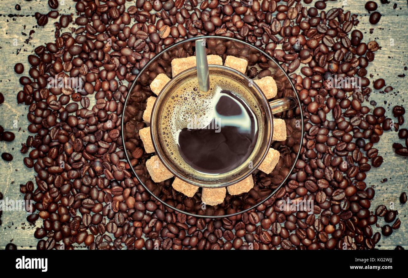 Cup of coffee with lump sugar in the background with coffee beans Stock ...