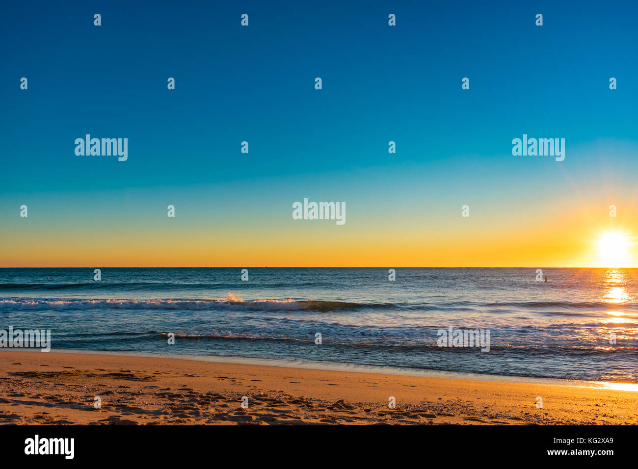 glowing yellow sun rising on the horizon on a cool clear morning at the ...