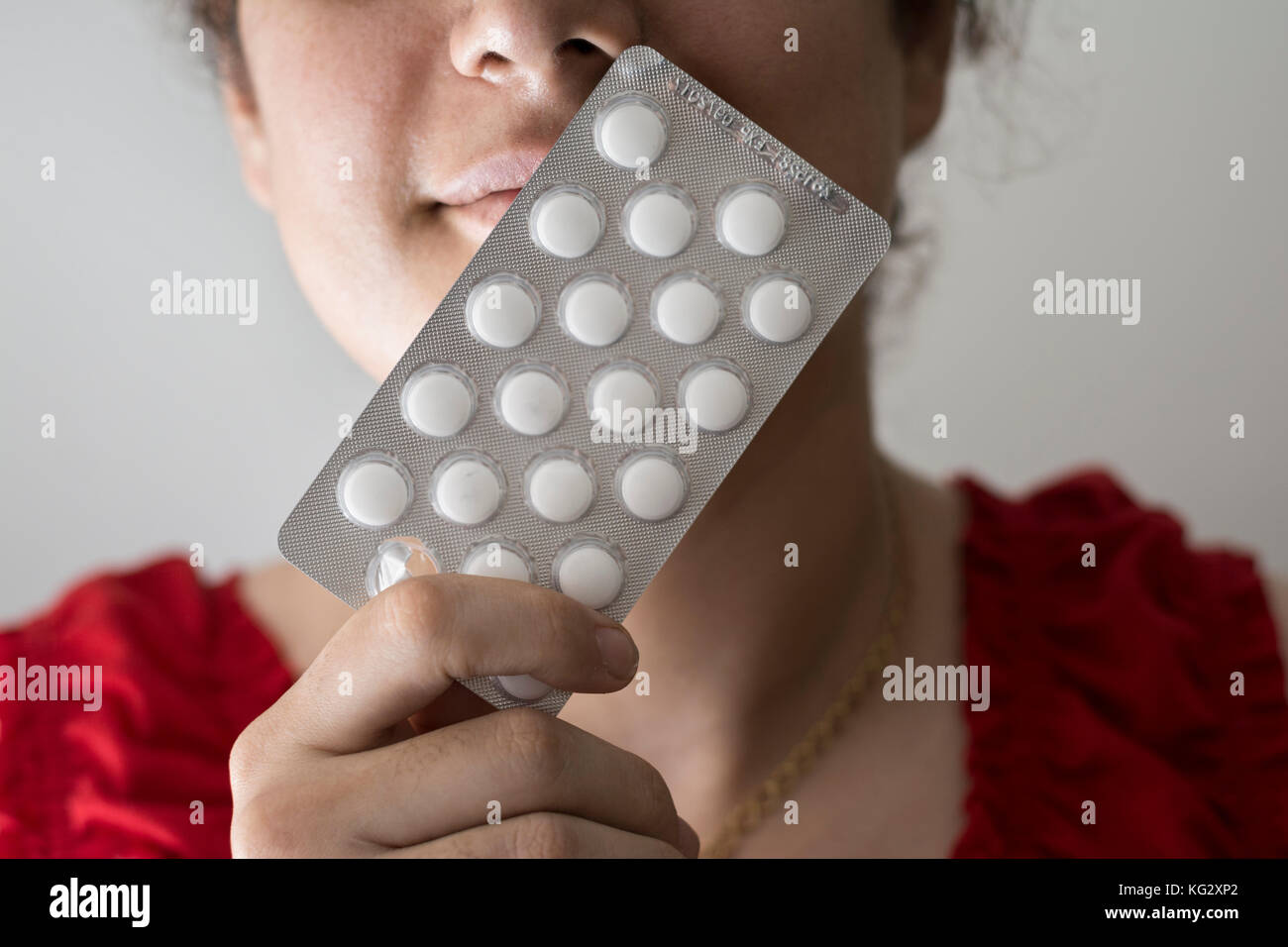 Woman Holding A Loaf of Tablets In Front of Her Face Stock Photo - Alamy