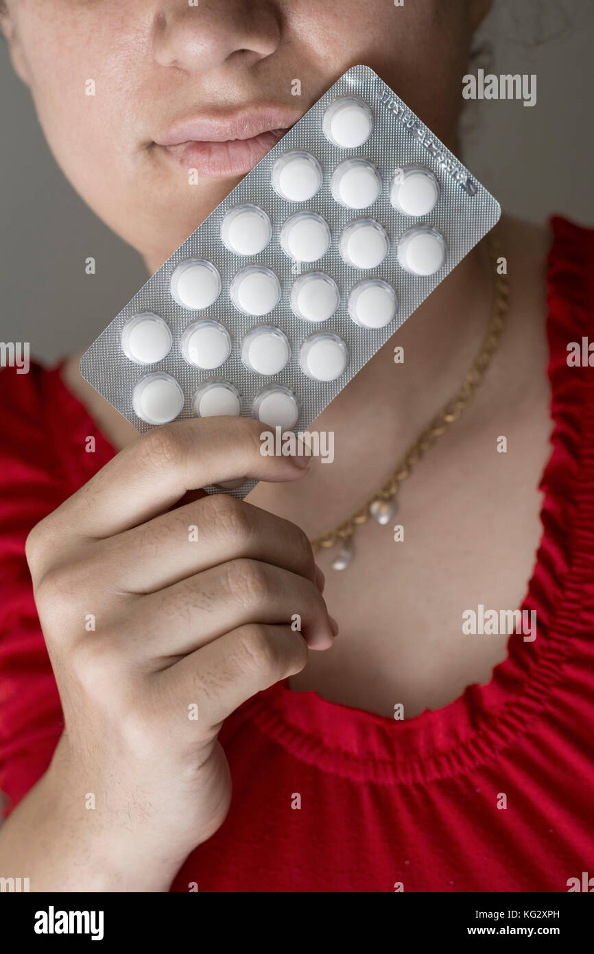 Woman Holding A Loaf of Tablets In Front of Her Face Stock Photo - Alamy