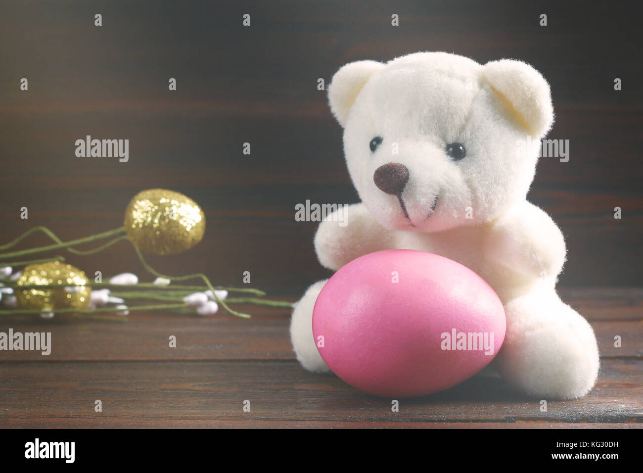 Teddy Bear holding an Easter egg, chicken, wood background Stock Photo ...