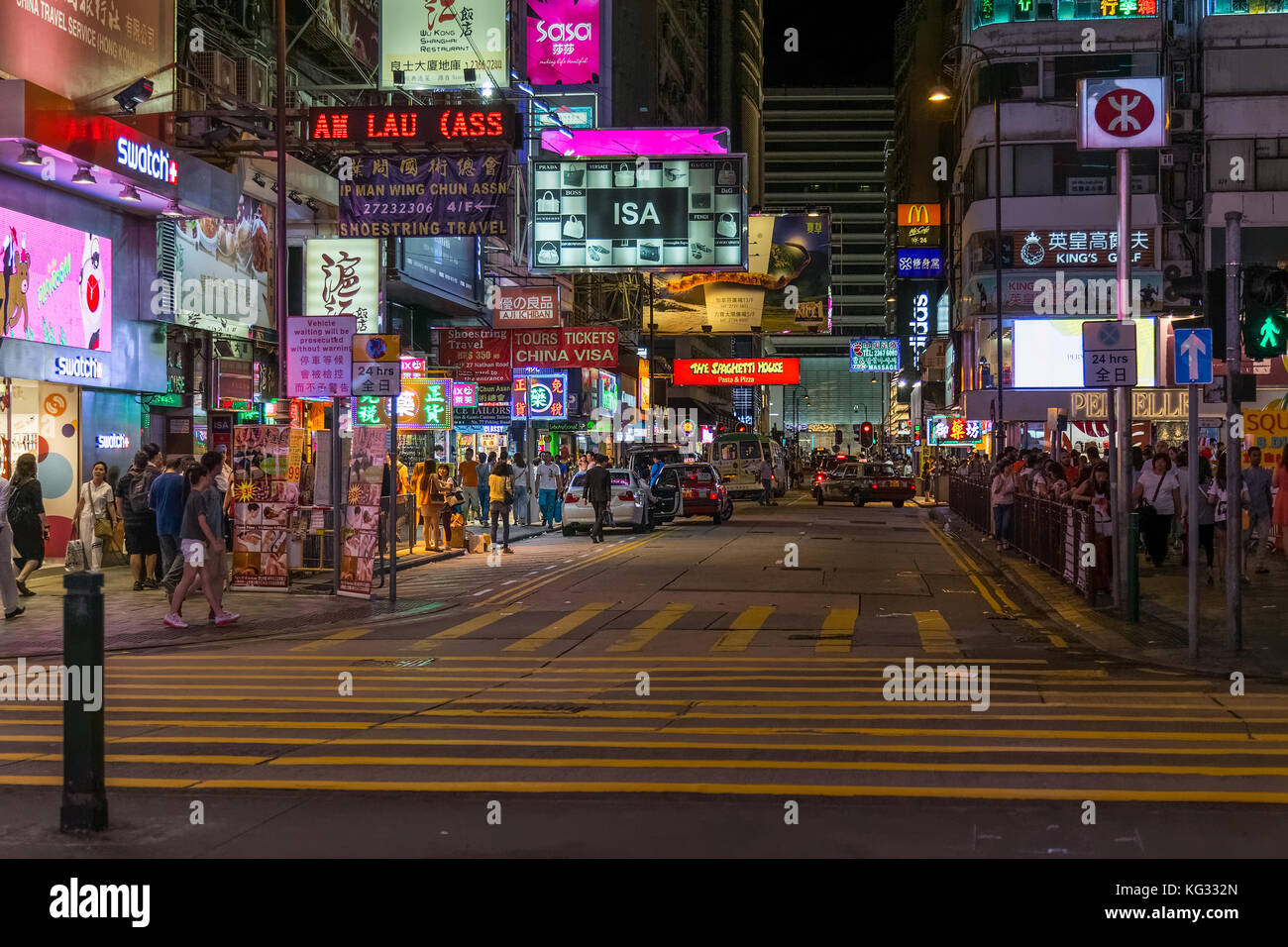Streets of Hong Kong with pedestrians, lights and neon signs at night ...