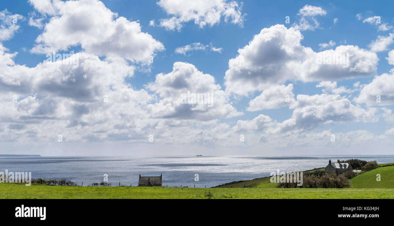 Coast of Longrock in Cornwall with houses, sea, ship and many clouds in ...