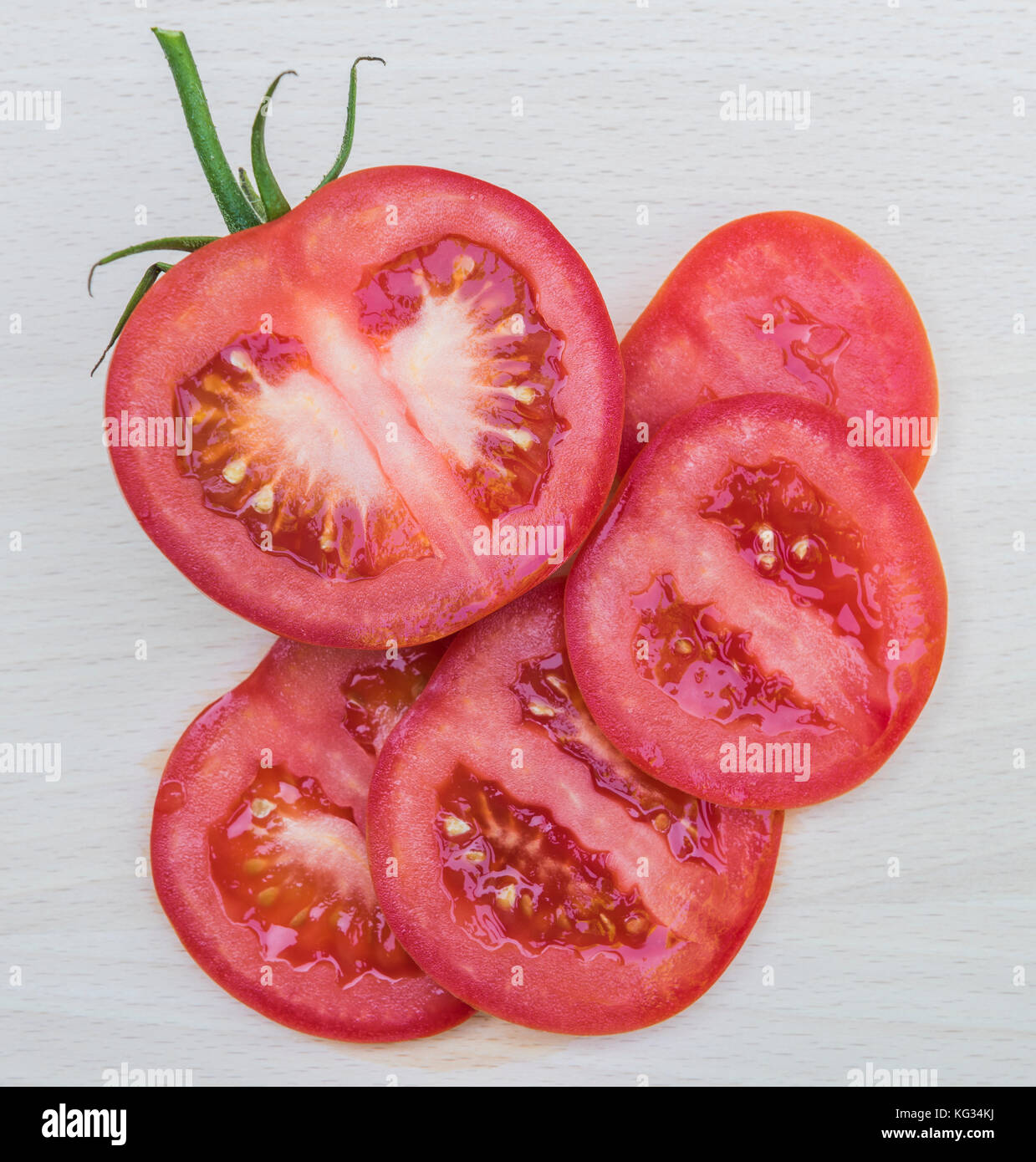 Cut tomato in slices on a cutting board Stock Photo - Alamy