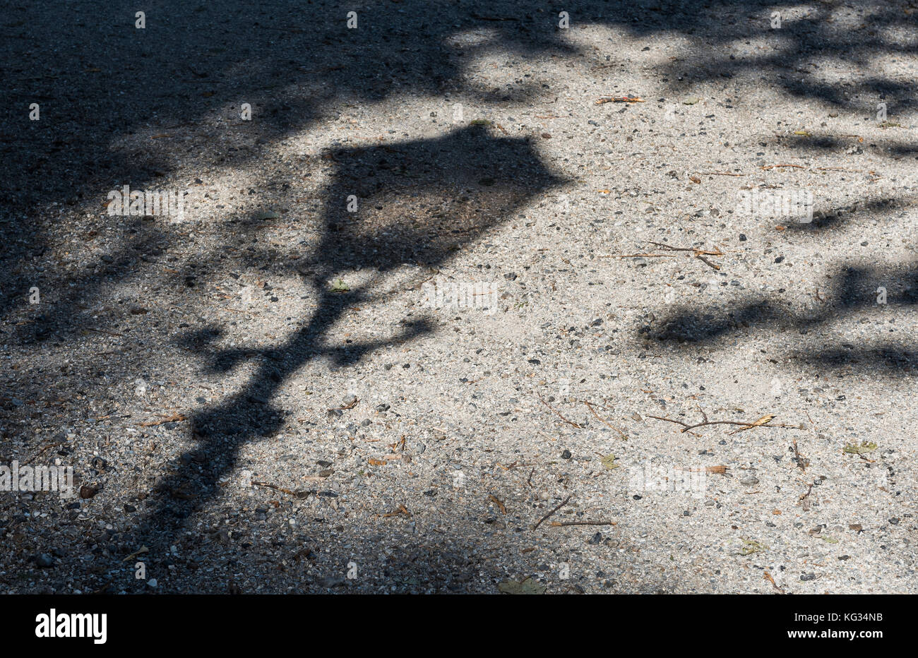 Shadow of a lantern on the ground gravel Stock Photo - Alamy