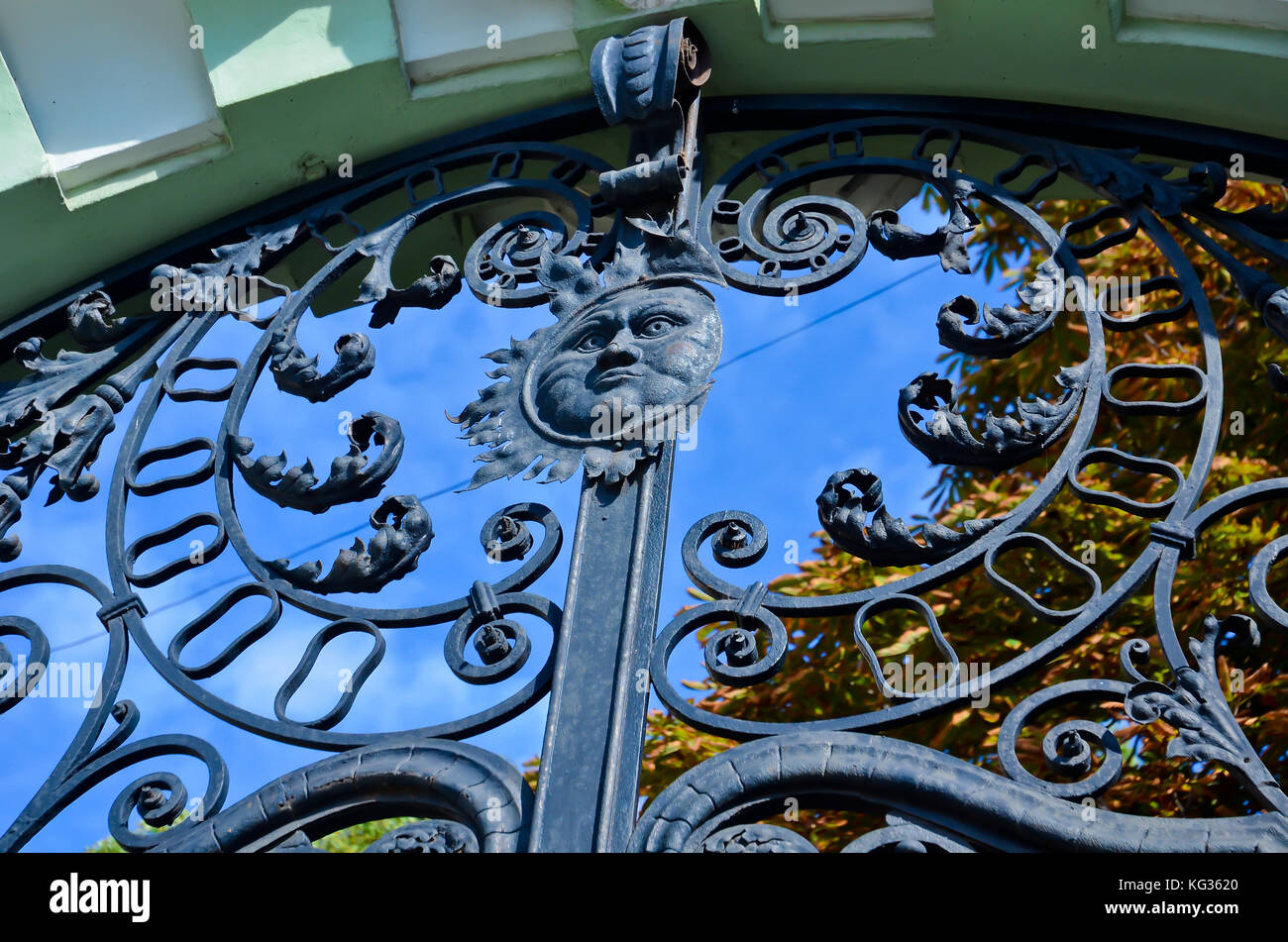 old rustic decorated gate with symbol of sun and blue sky Stock Photo ...