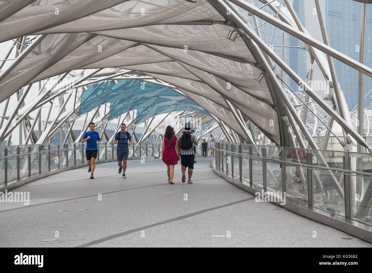 People walking and running on Helix Bridge in Singapore Stock Photo - Alamy