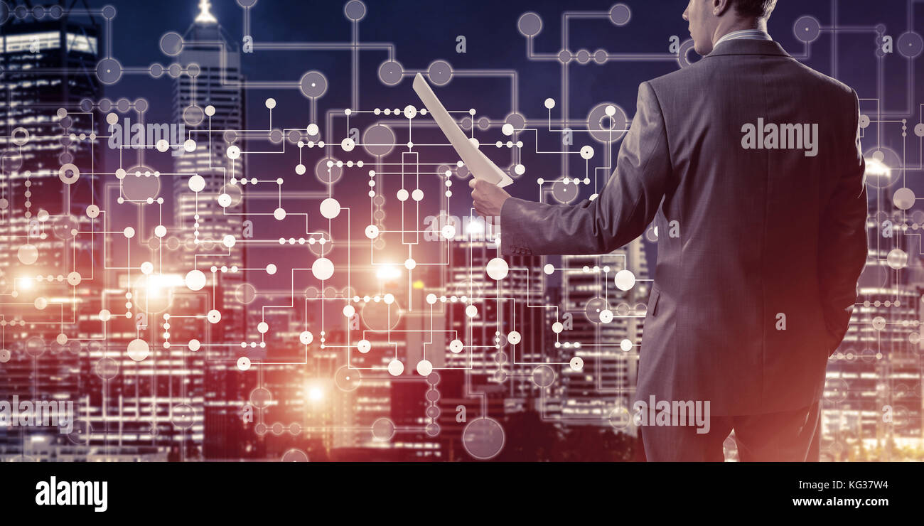 Rear view of businessman against night cityscape background and Stock ...