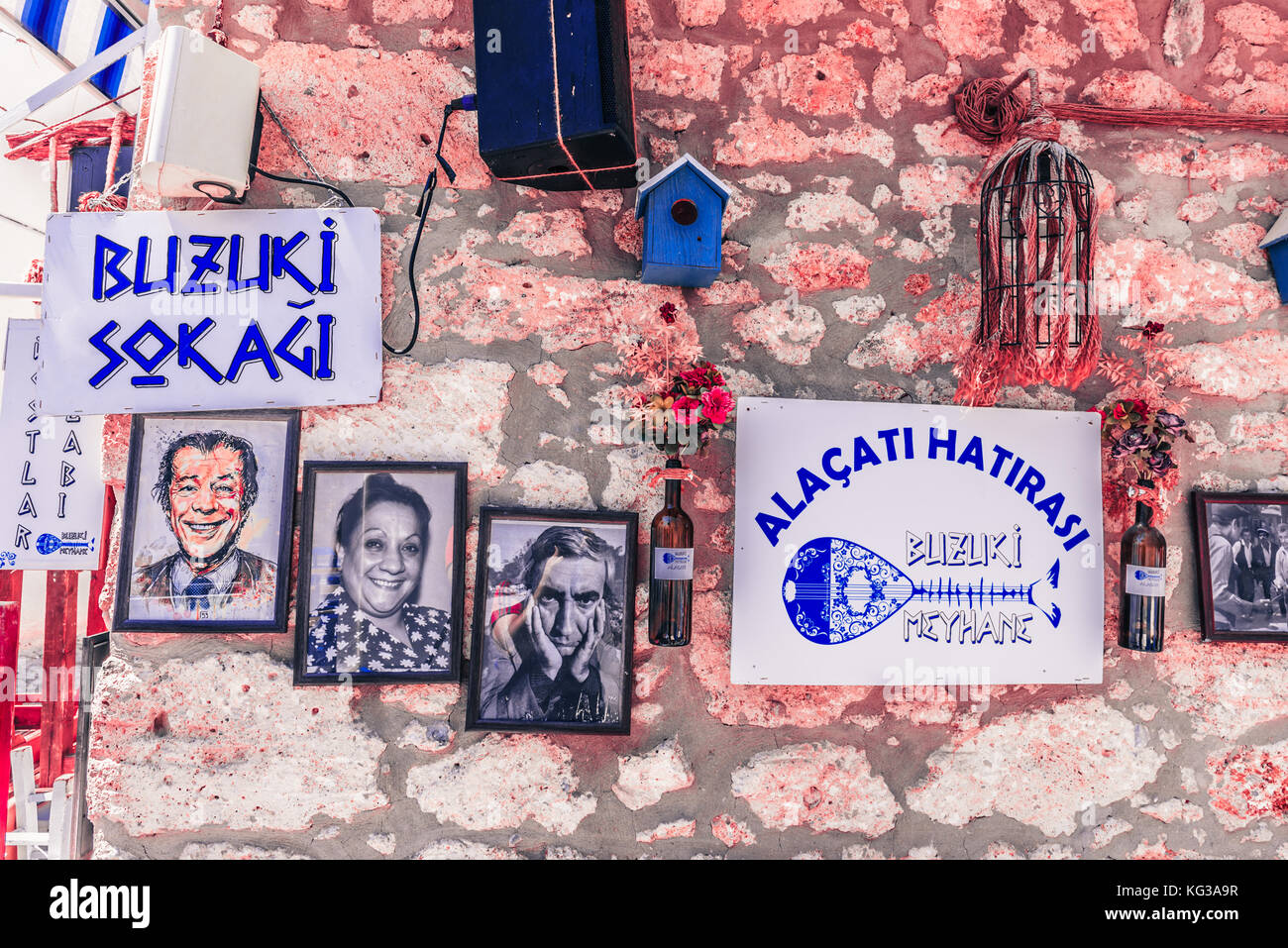 Frames with photos of famous Turkish people on white stone wall and a ...