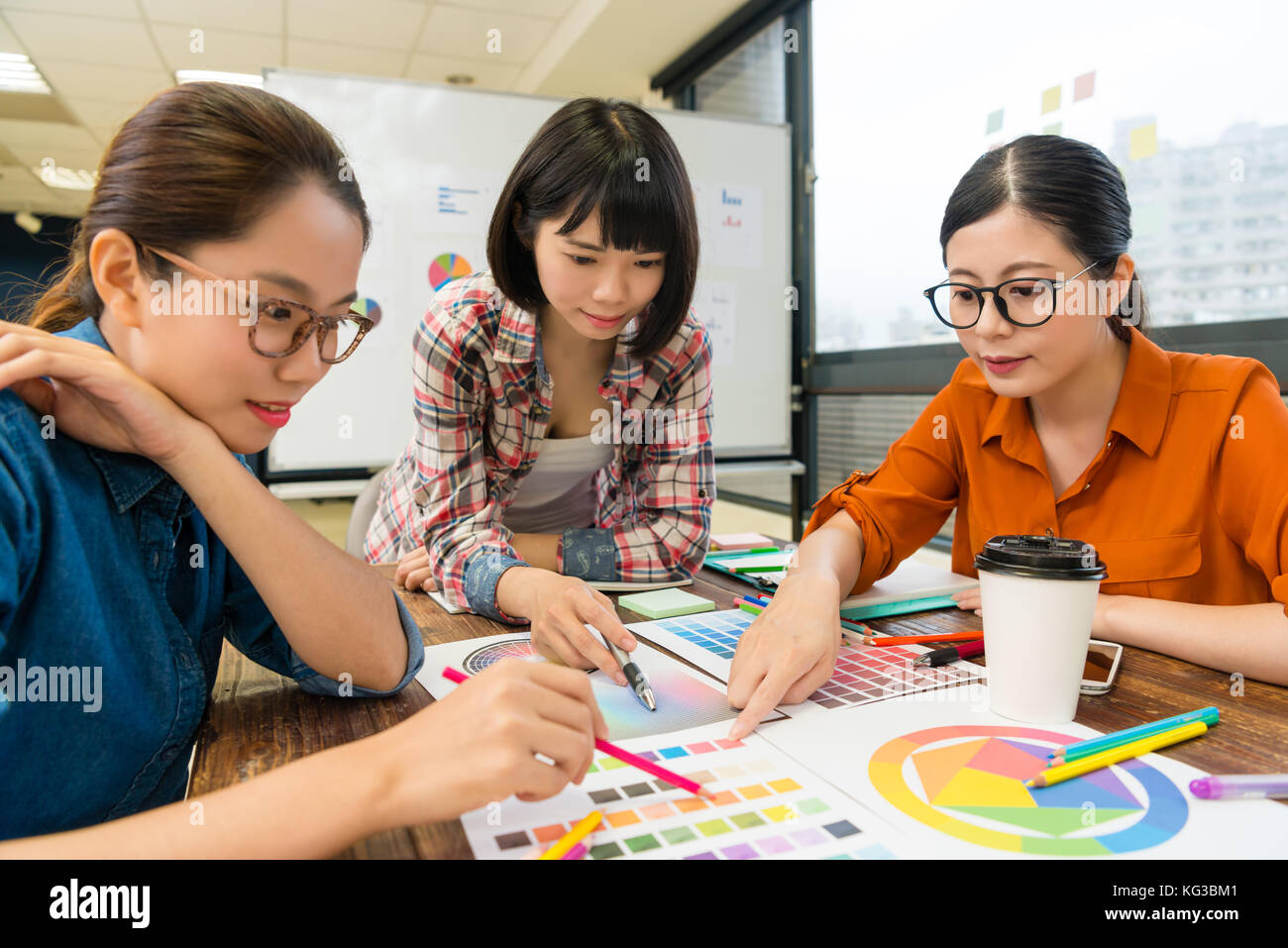 professional young female designer team meeting on conference desk and ...