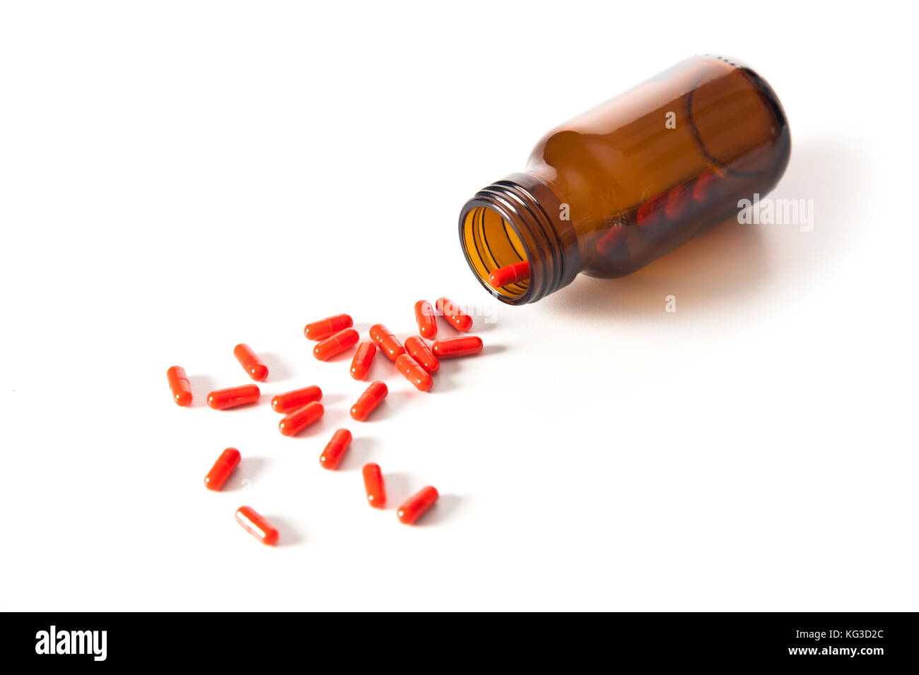 Red medicine pill in bottle isolated on white background Stock Photo ...