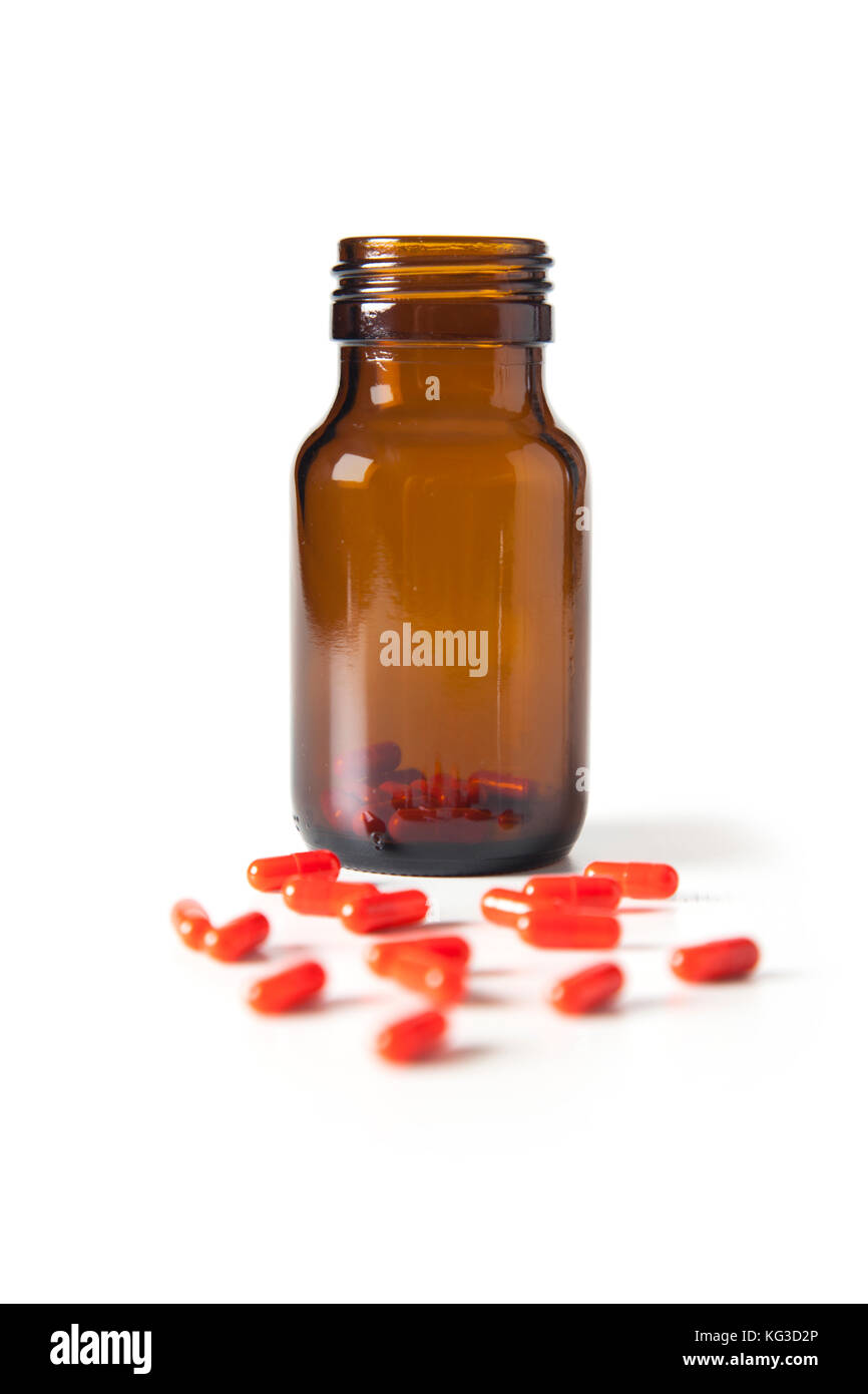 Red medicine pill in bottle isolated on white background Stock Photo ...