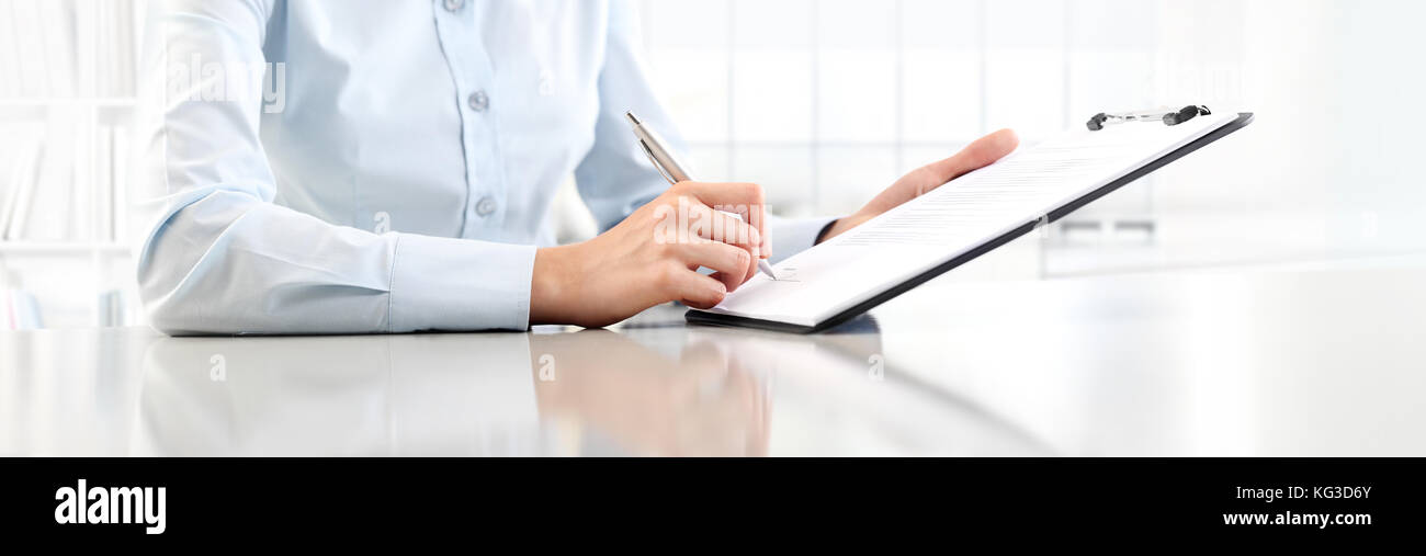 Woman's hands writing on sheet in a clipboard with a pen, isolated on ...