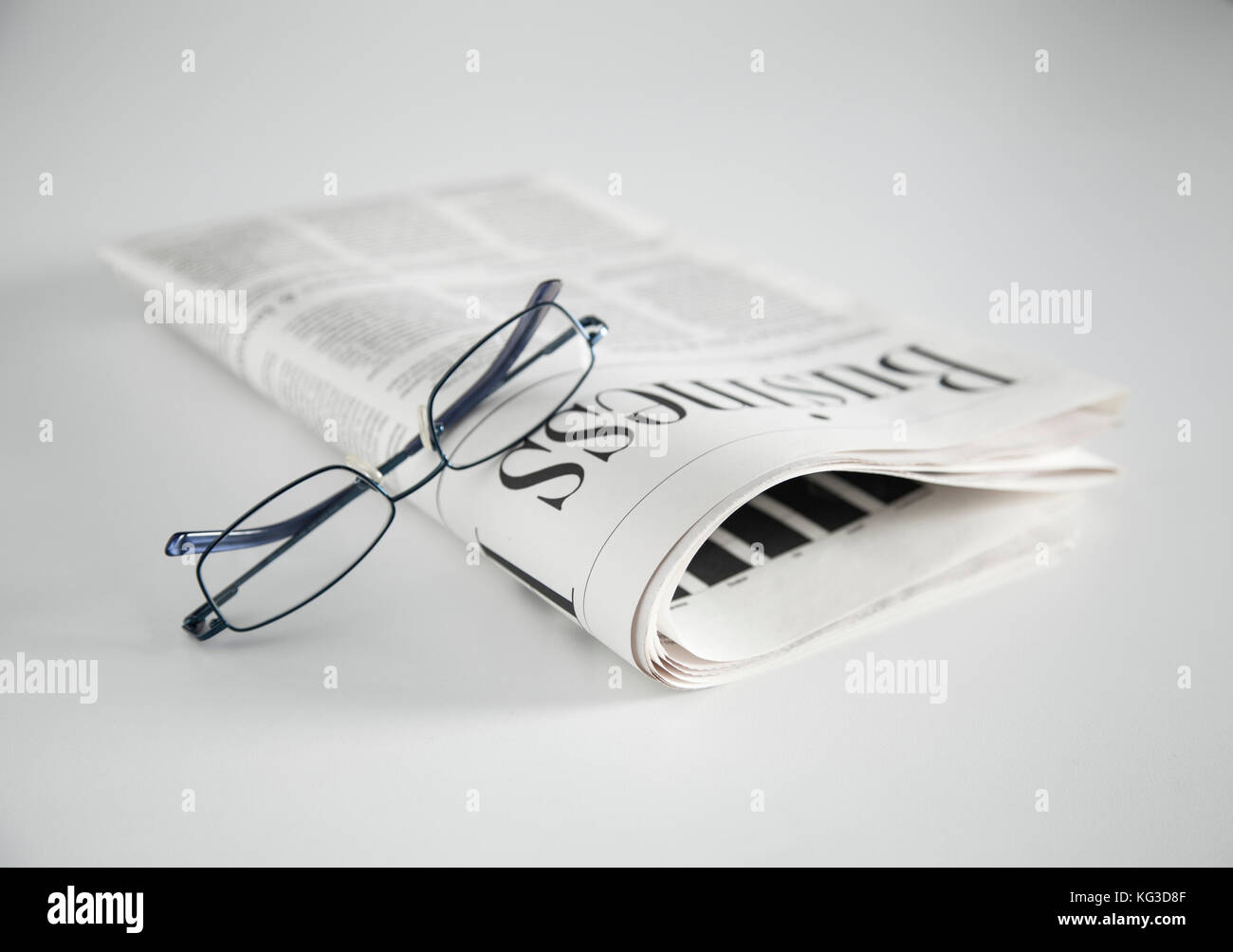 Newspaper and glasses on isolated white background Stock Photo - Alamy