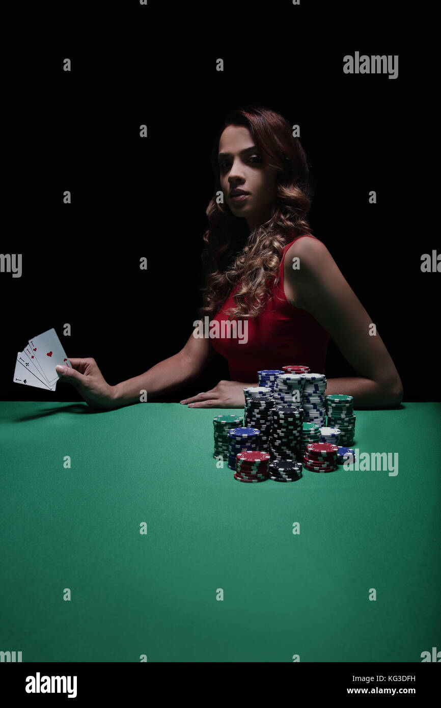 pretty young woman gambling on green table Stock Photo - Alamy