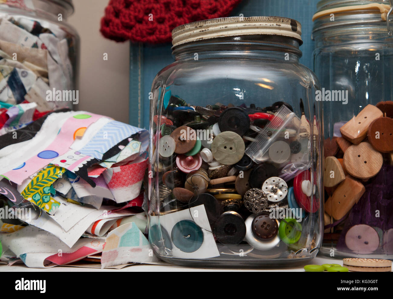 glass jars full of shapes and colors of buttons in a craft room Stock ...
