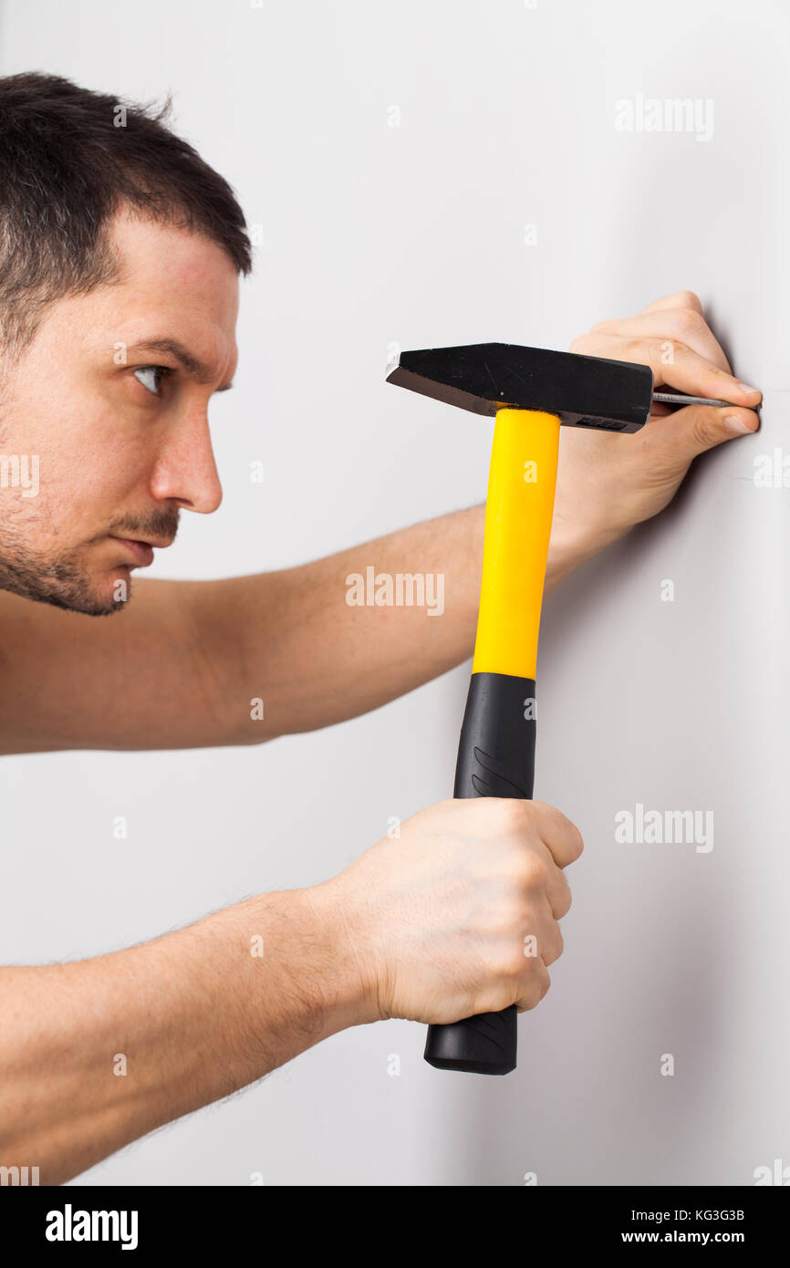 Man fixing nail with hammer Stock Photo - Alamy