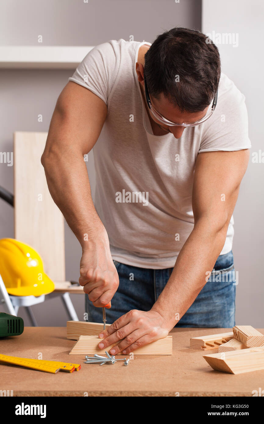 Carpenter working screw in the board Stock Photo - Alamy