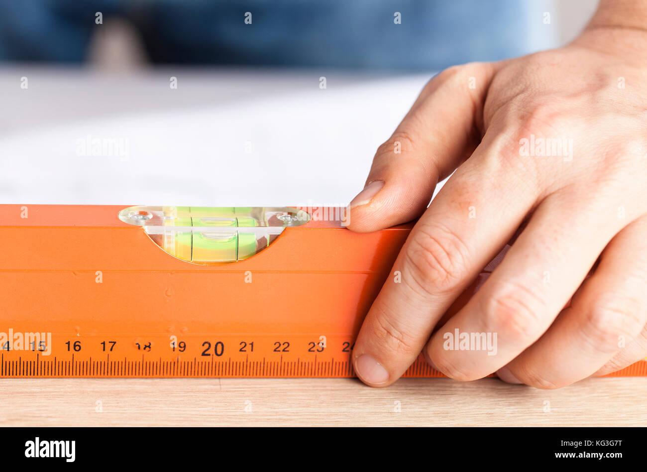 Craftsman measuring a plank of wood with a spirit level Stock Photo - Alamy