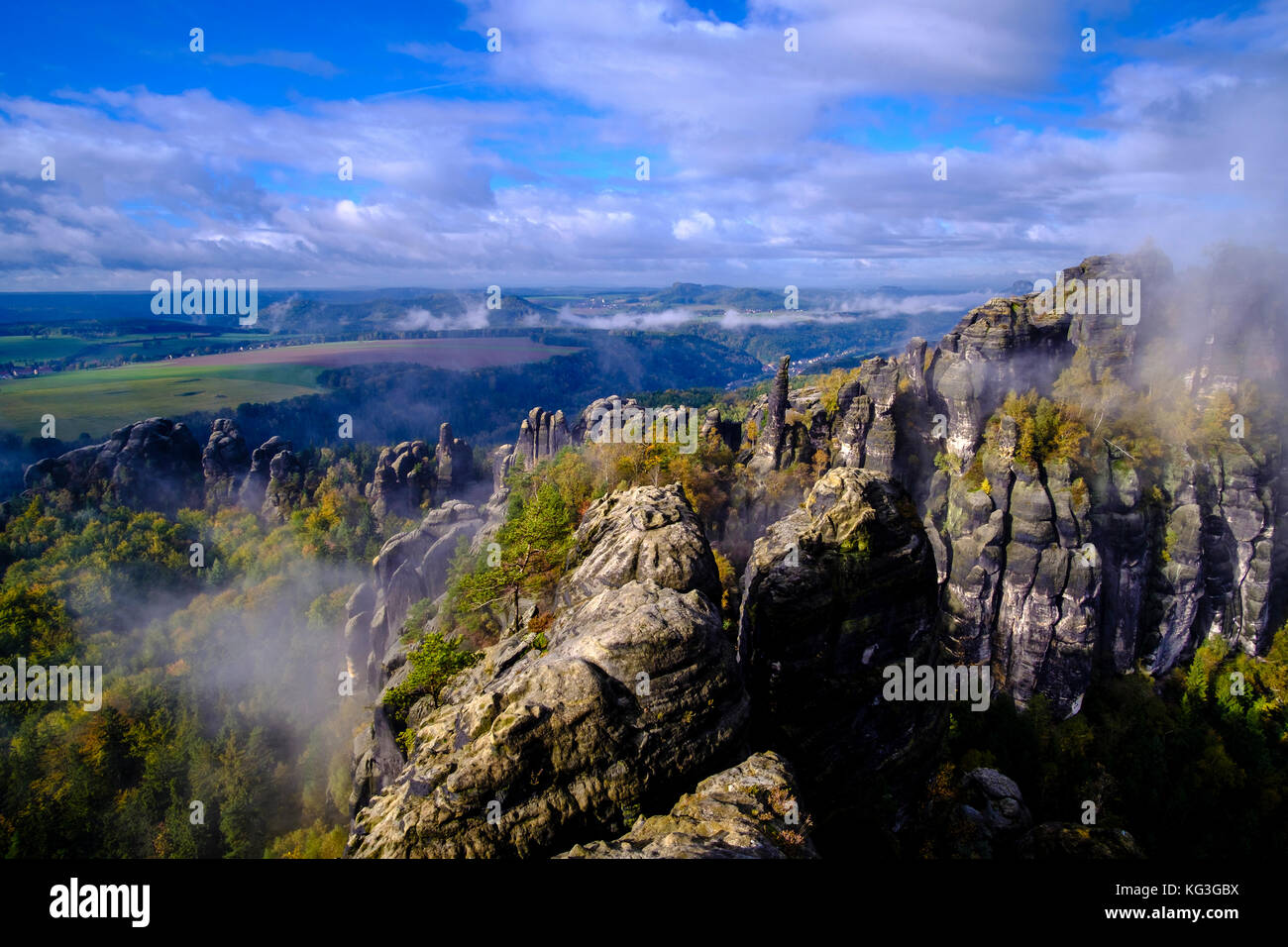 Landscape with the fog covered river Elbe valley and the mountain range ...