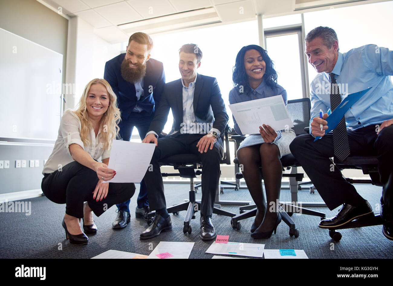 Portrait of a diverse group of smiling work colleagues brainstorming ...