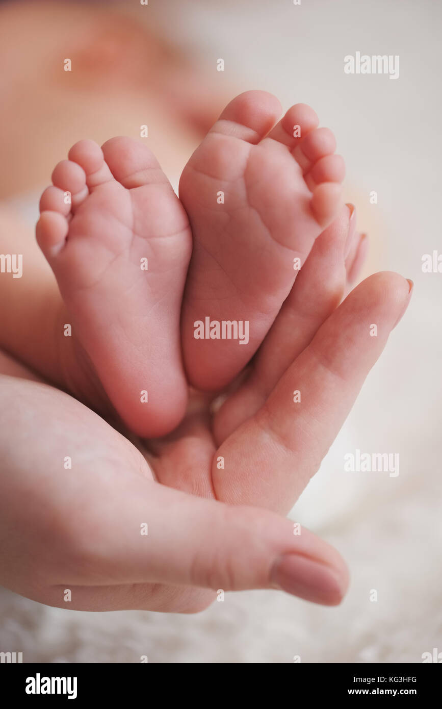 mother holds cute little foot of newborn baby Stock Photo - Alamy