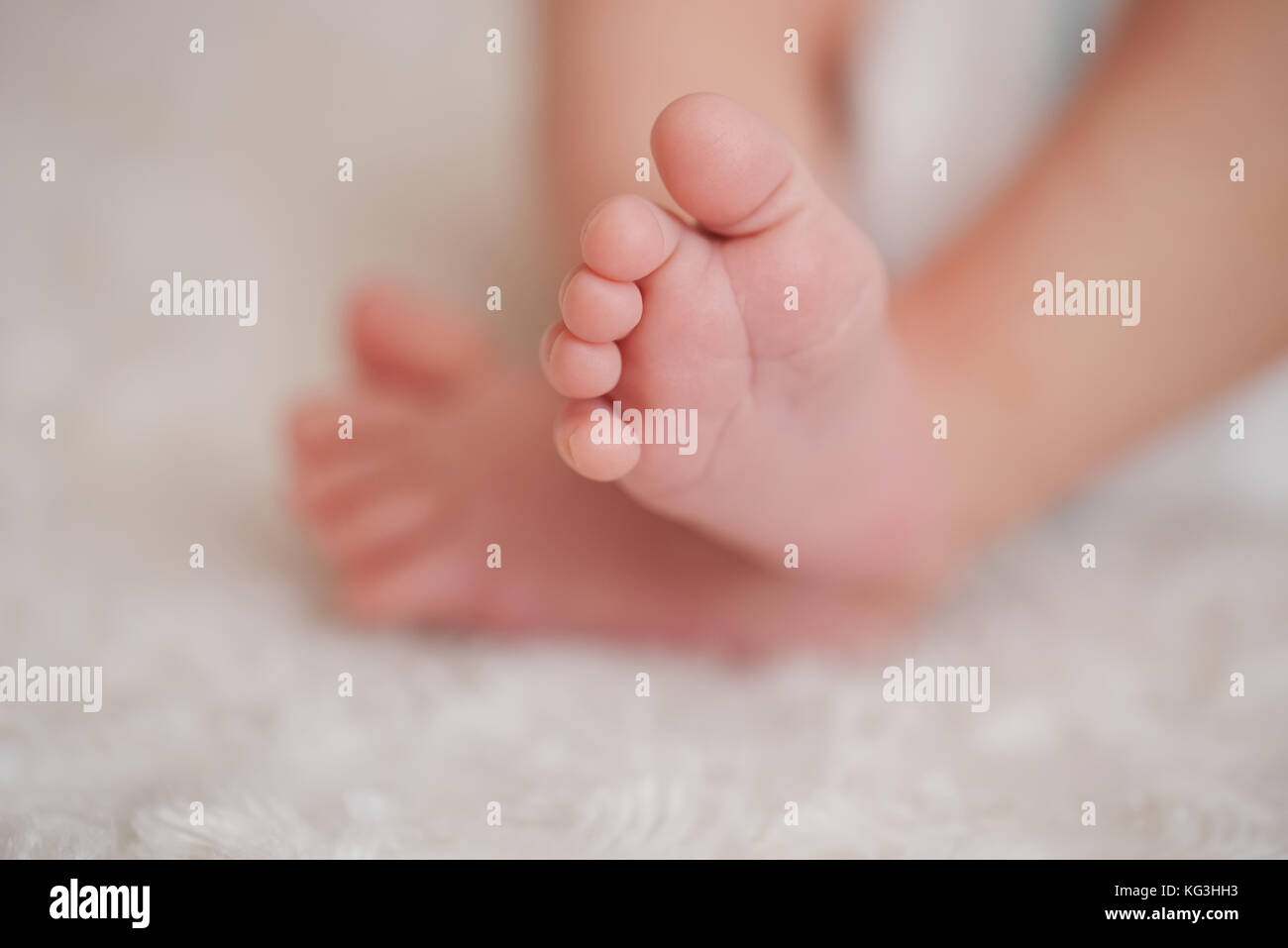 mother holds cute little foot of newborn baby Stock Photo - Alamy
