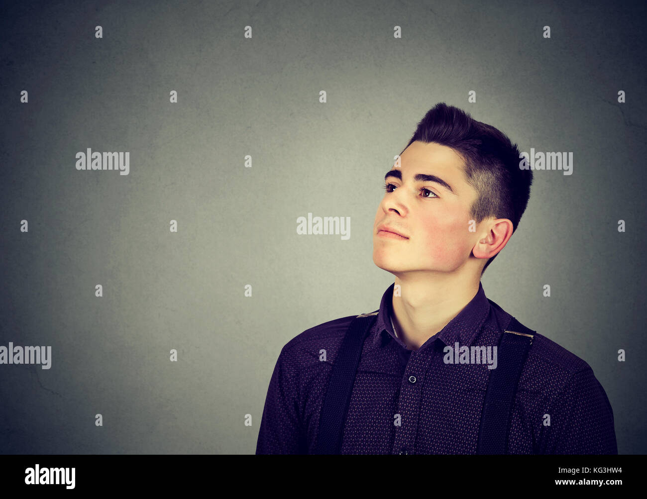 Thoughtful happy young man looking up Stock Photo - Alamy