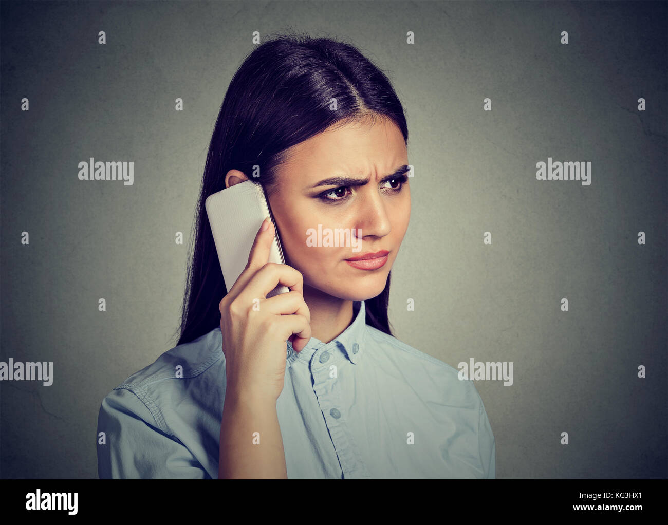 Closeup portrait, sad, unhappy woman talking on phone, isolated on gray ...