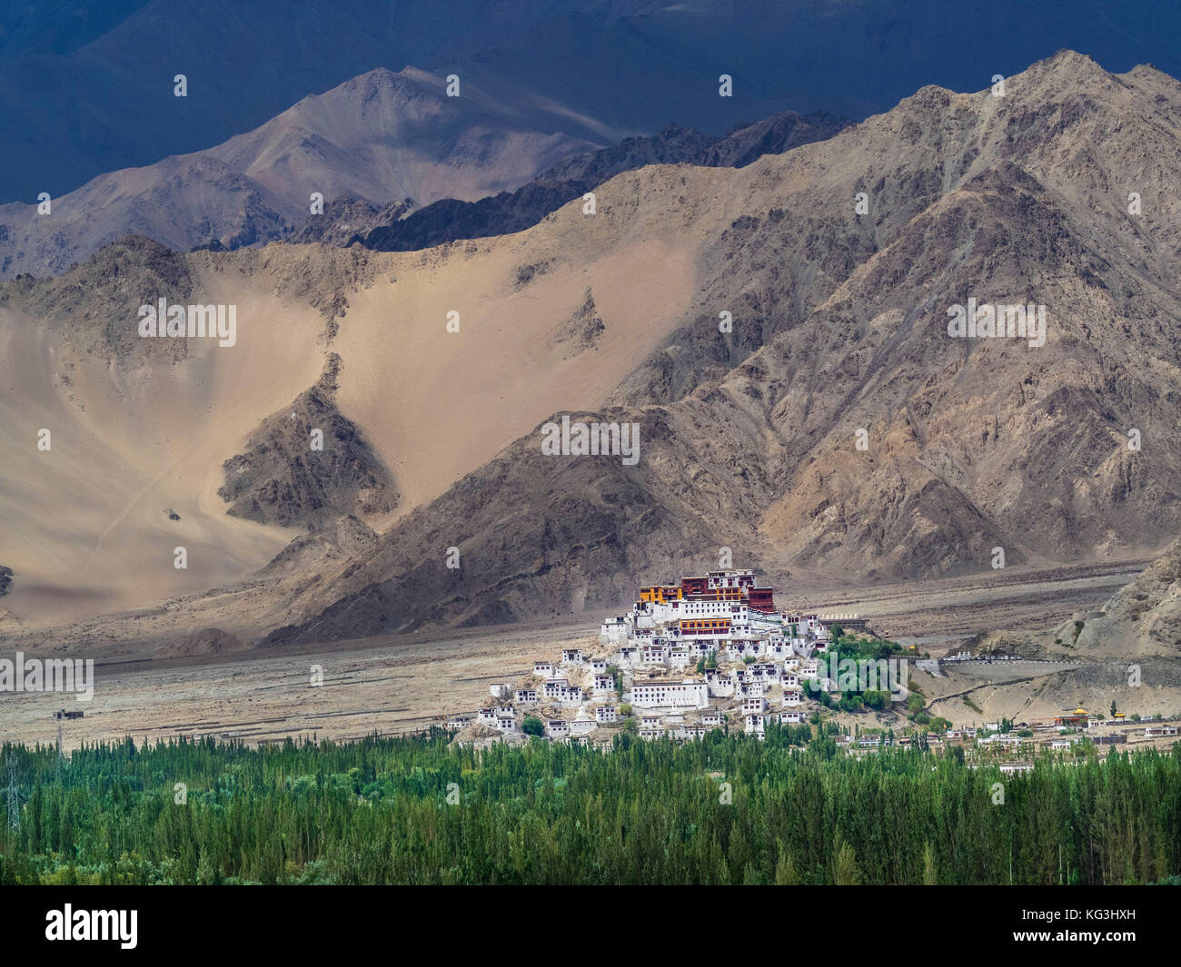 Buddhist city Tiksi monastery against the backdrop of huge mountains of ...