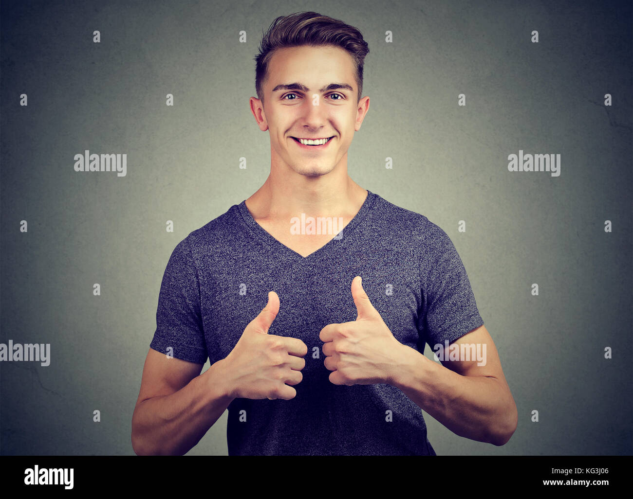 Happy handsome man showing thumbs up gesture with two hands Stock Photo ...
