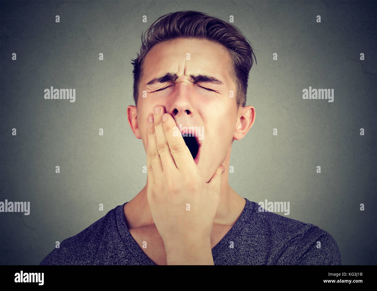 Sleepy young man yawning. Sleep deprivation, burnout, laziness concept ...