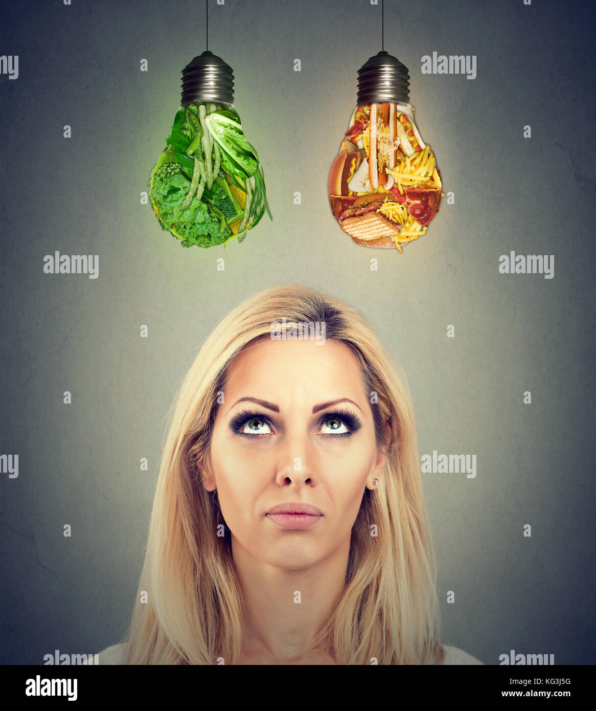 Woman thinking making a diet choice looking up at junk food and green ...