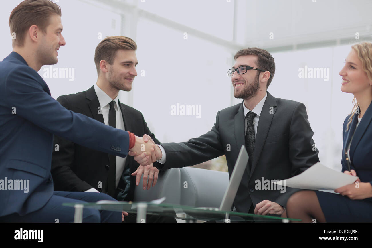 Handshake between businesspeople in a modern office Stock Photo - Alamy