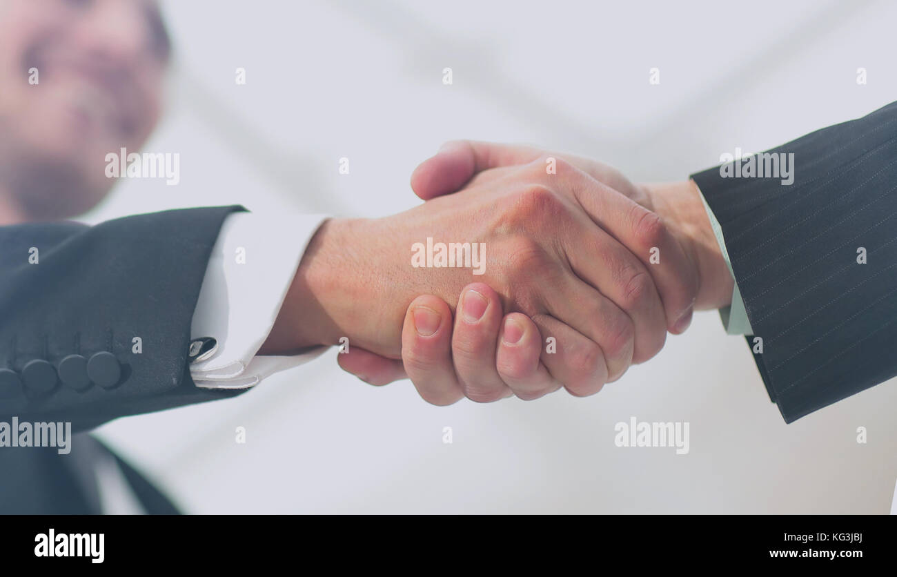 Businessman by handshake invites to cooperation Stock Photo - Alamy