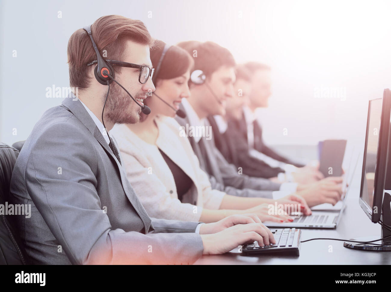 operators with headsets in front of computers in the call center Stock ...