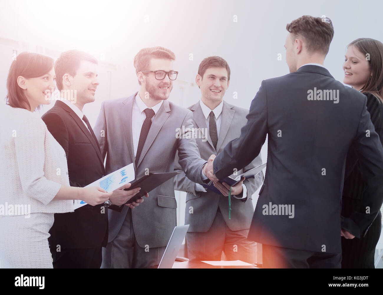 business partners in the presence of a business team shake hands Stock ...