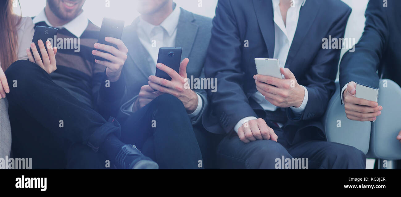 Group of young people use their phones Stock Photo - Alamy