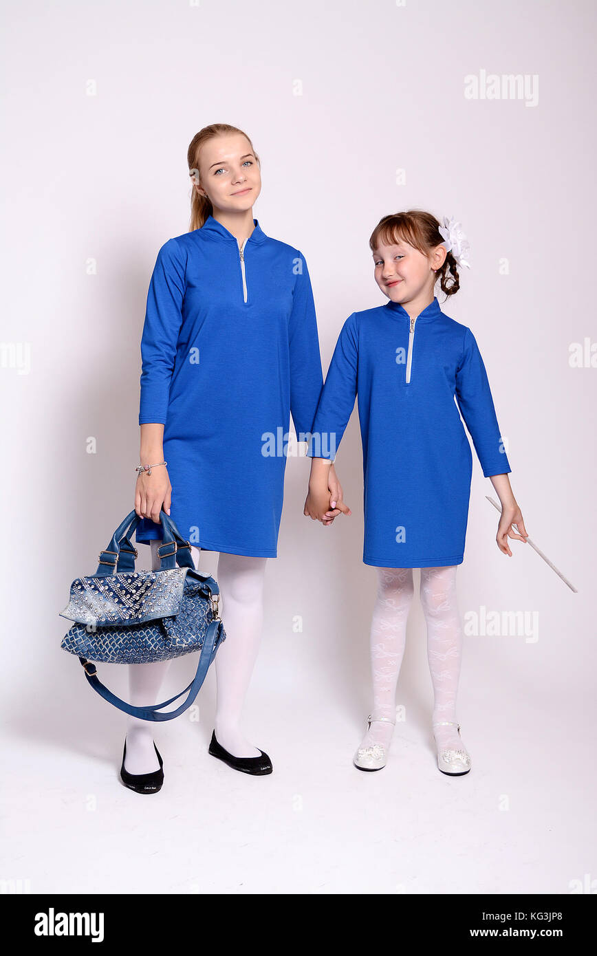 Beautiful young school girl advertises school uniforms.Isolated studio ...