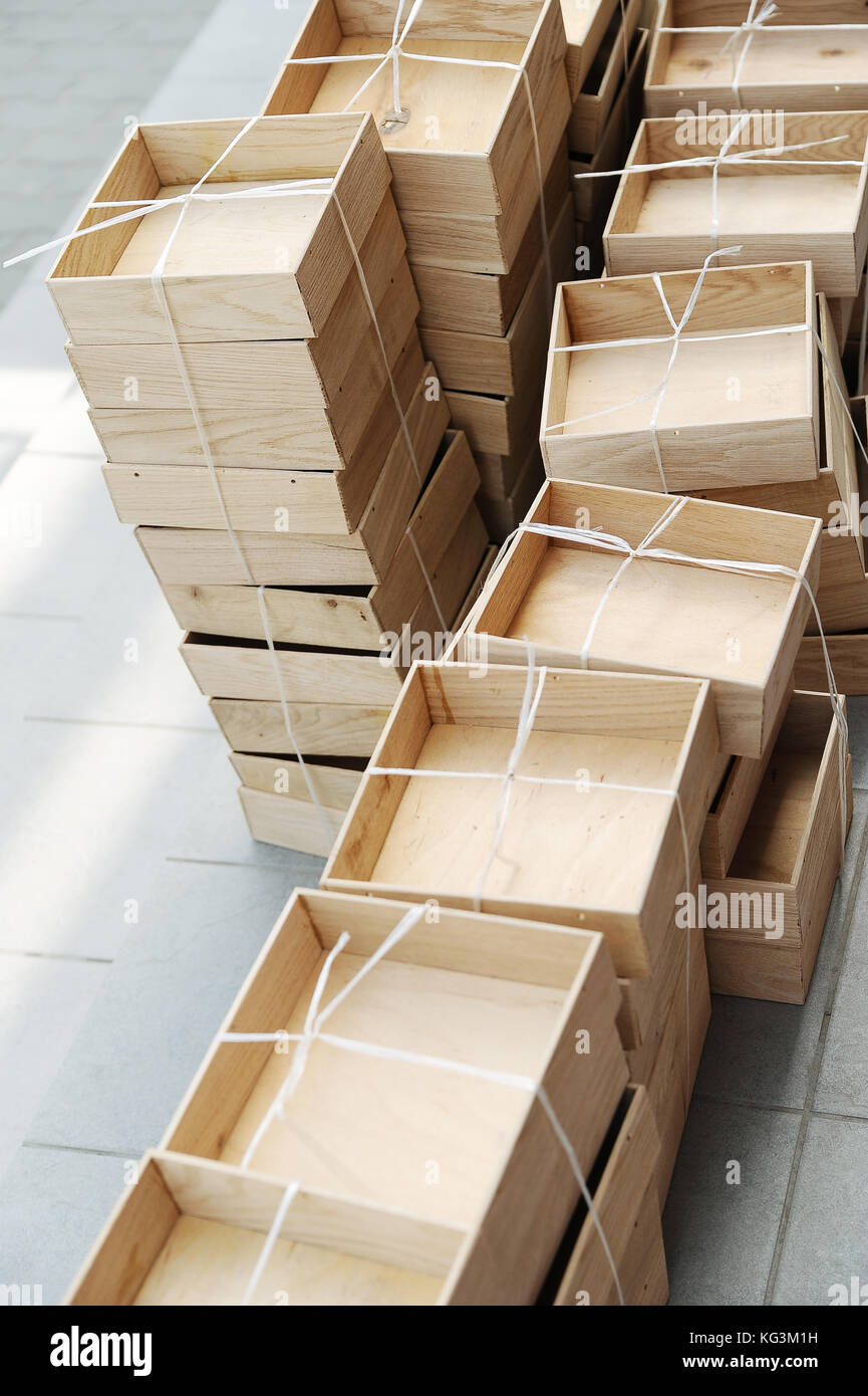 Square wooden boxes, connected by a rope Stock Photo - Alamy