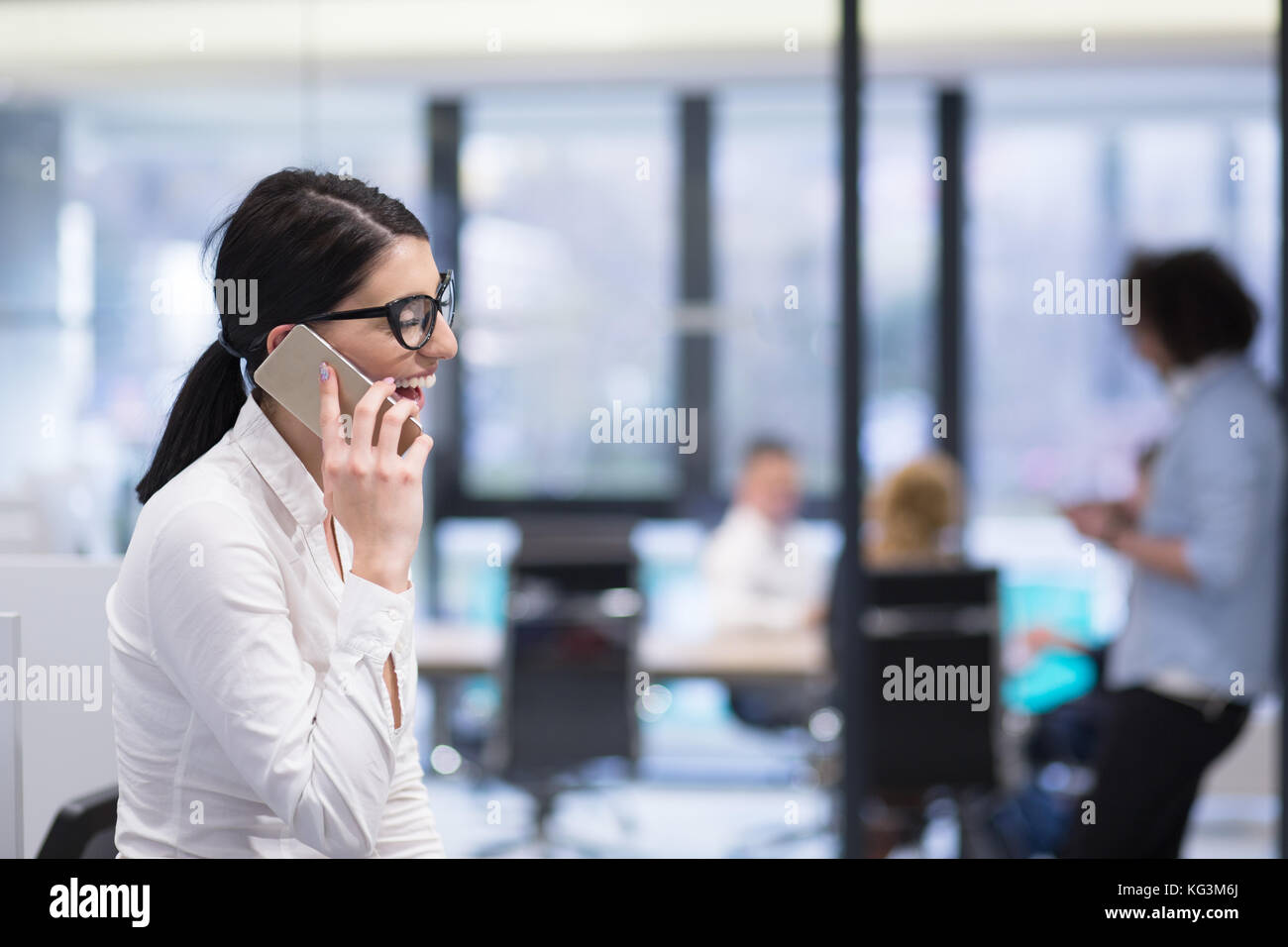 female manager using cell telephone in startup office interior Stock ...