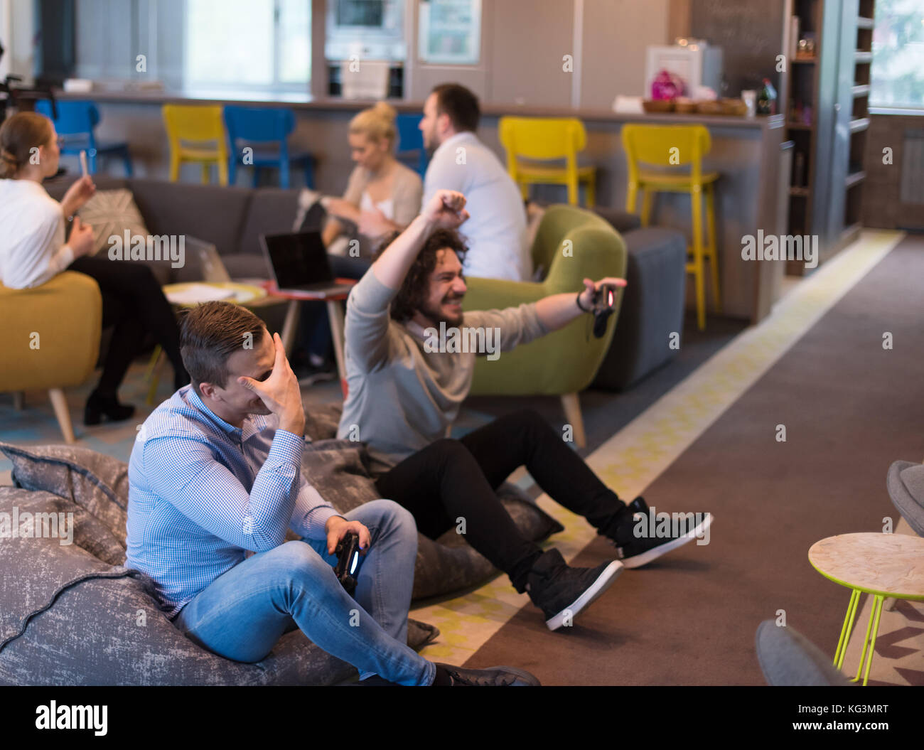 Work hard play hard. Workers Playing computer games in creative startup ...